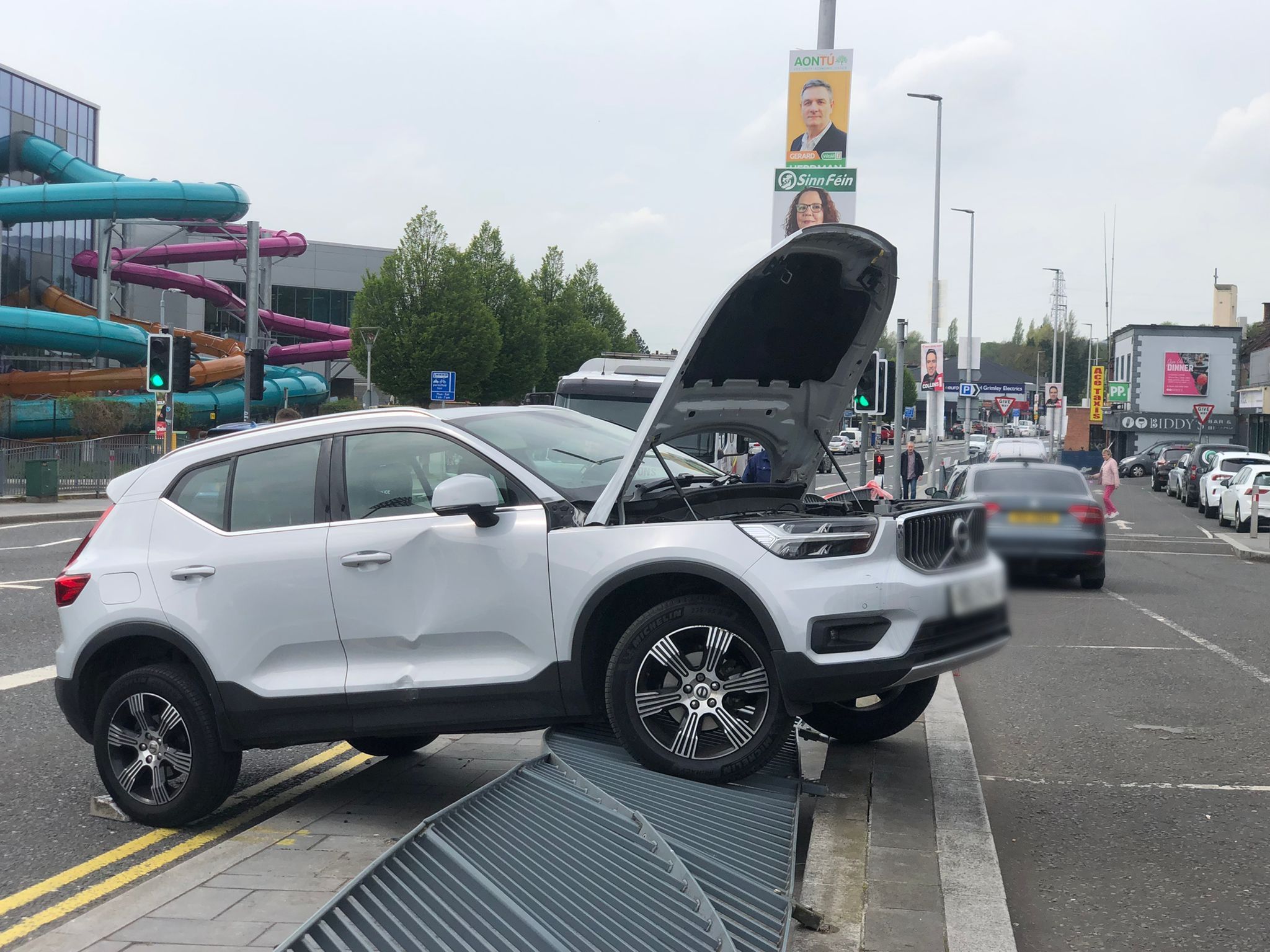 Lucky escape after car reverses through railings onto Andersonstown Road