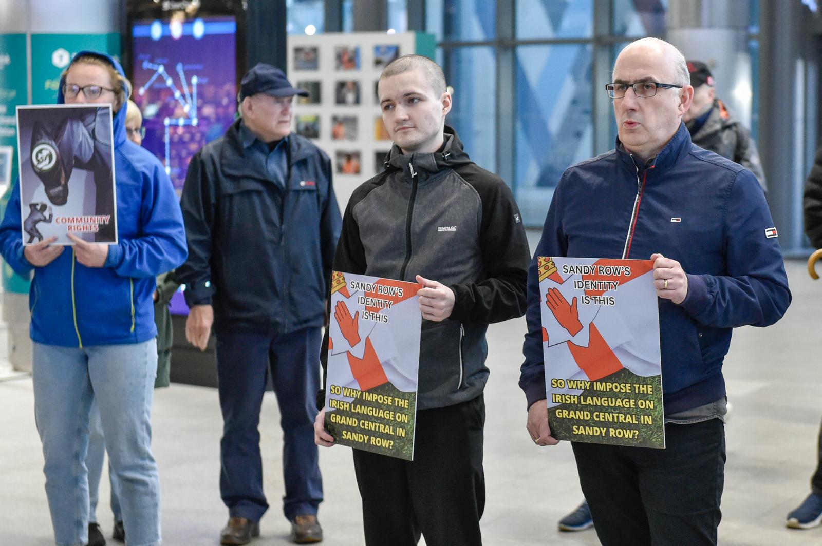 Tiny turn-out for demo against dual-language signage at Grand Central